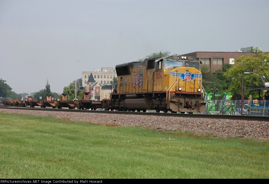 A bare table train heads west. Maybe to Global One.